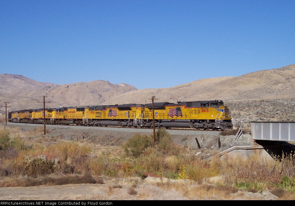 UP 8615 is the lead unit of a mixed freight about to cr`ss Burnt River